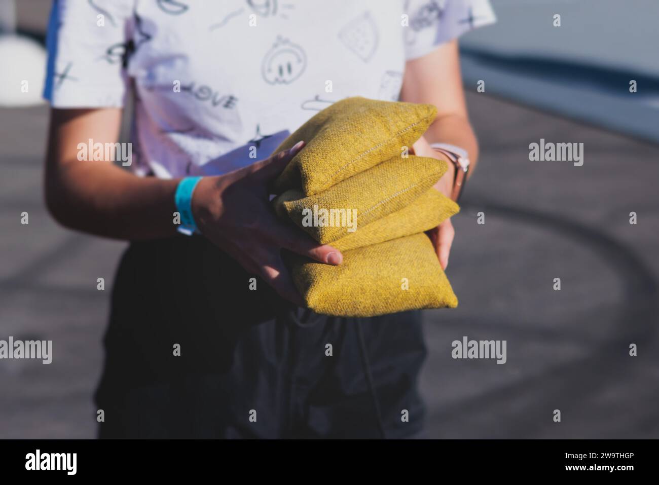 Cornhole game set, process of throwing bean bags, kids children tossing ...