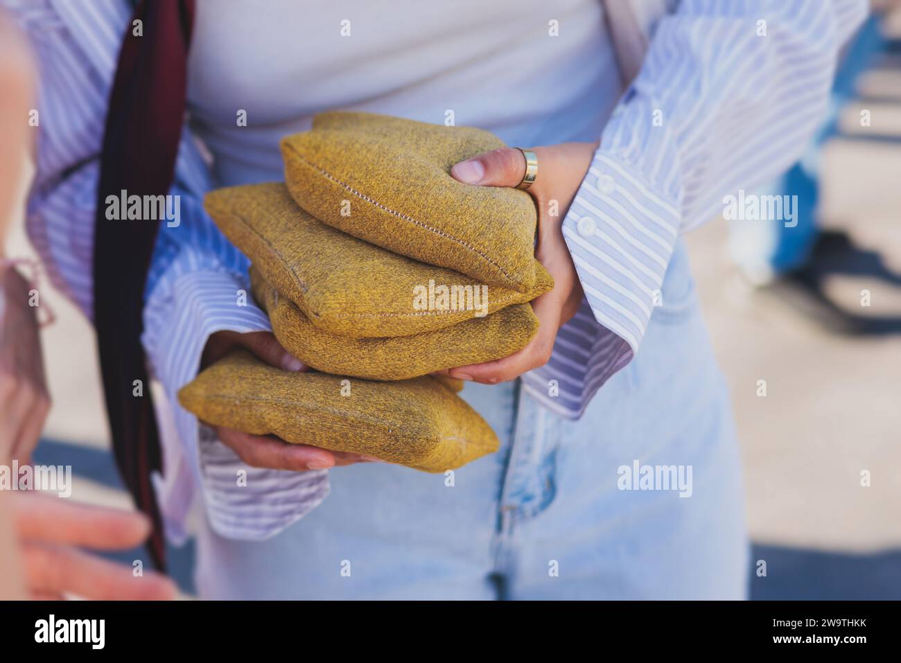 Cornhole game set, process of throwing bean bags, kids children tossing ...