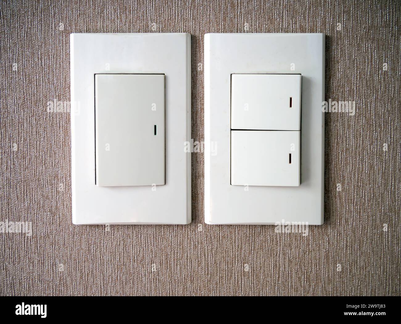 Vertically oriented light switches in the house Stock Photo - Alamy