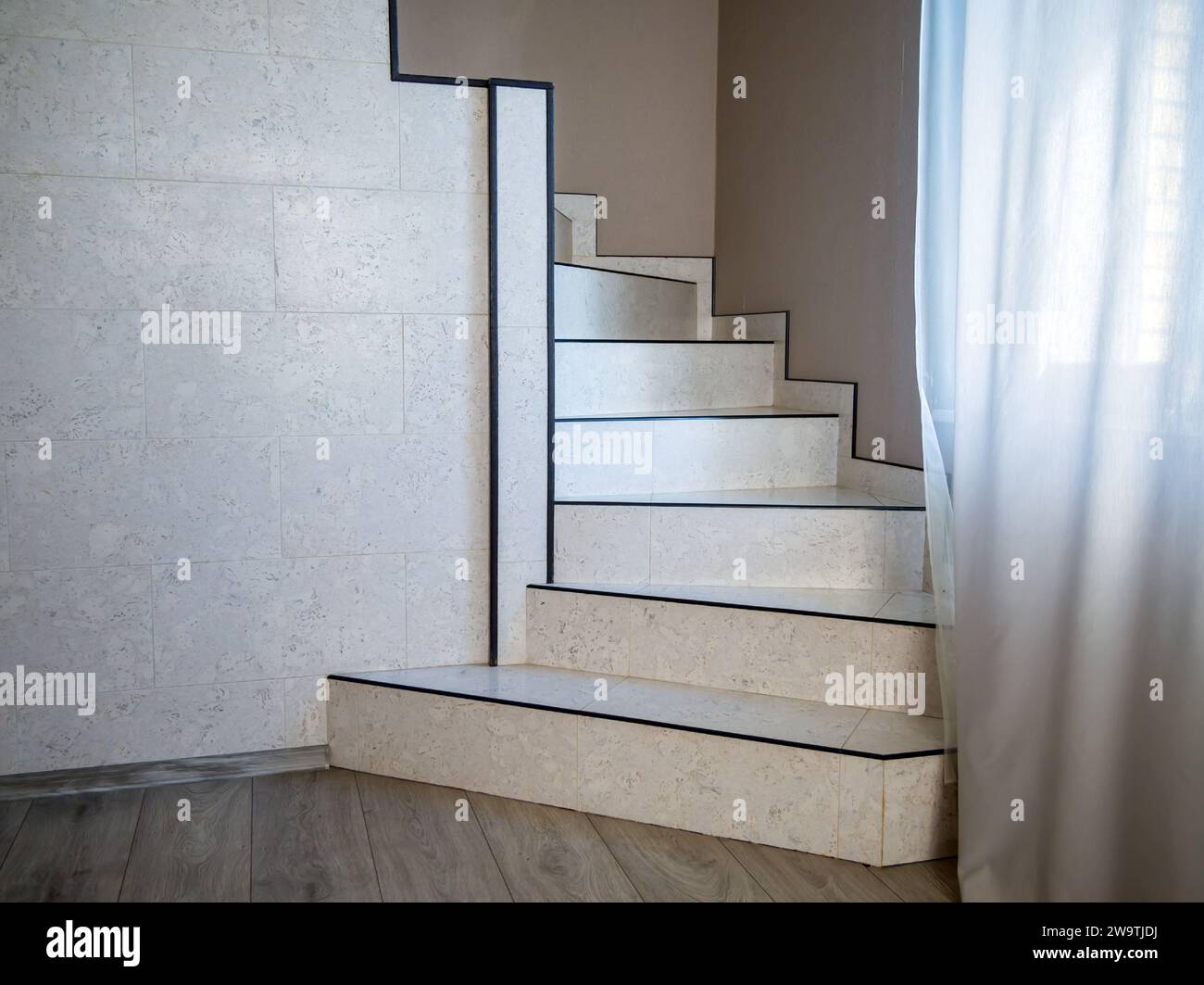 Staircase finished with ceramic tiles and leading to the second floor ...