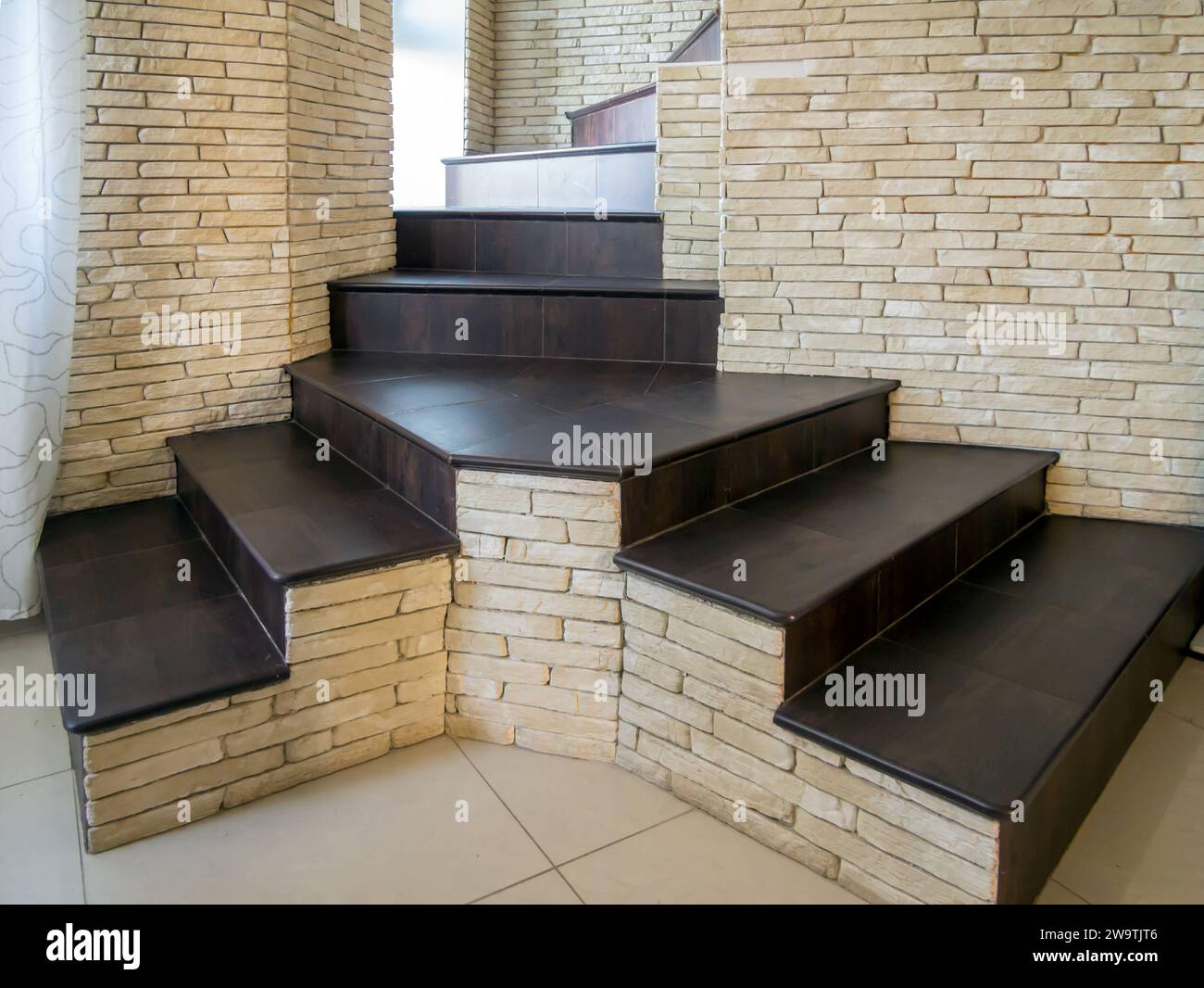 Staircase podium with brown stone steps in the hall of the house Stock ...