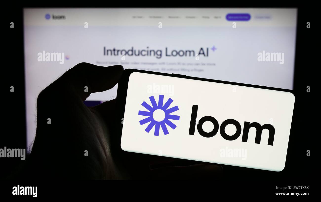 Person holding cellphone with logo of US video communication software ...