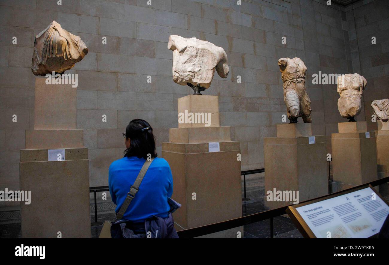 London, UK. 30th Dec, 2023. Visitors at the British Museum view ancient sculptures in the ...