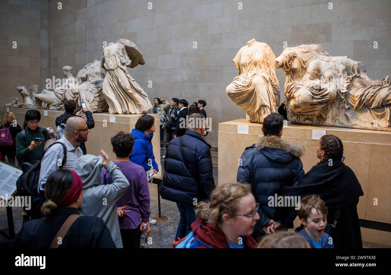 London, UK. 30th Dec, 2023. Visitors at the British Museum view ancient sculptures in the ...