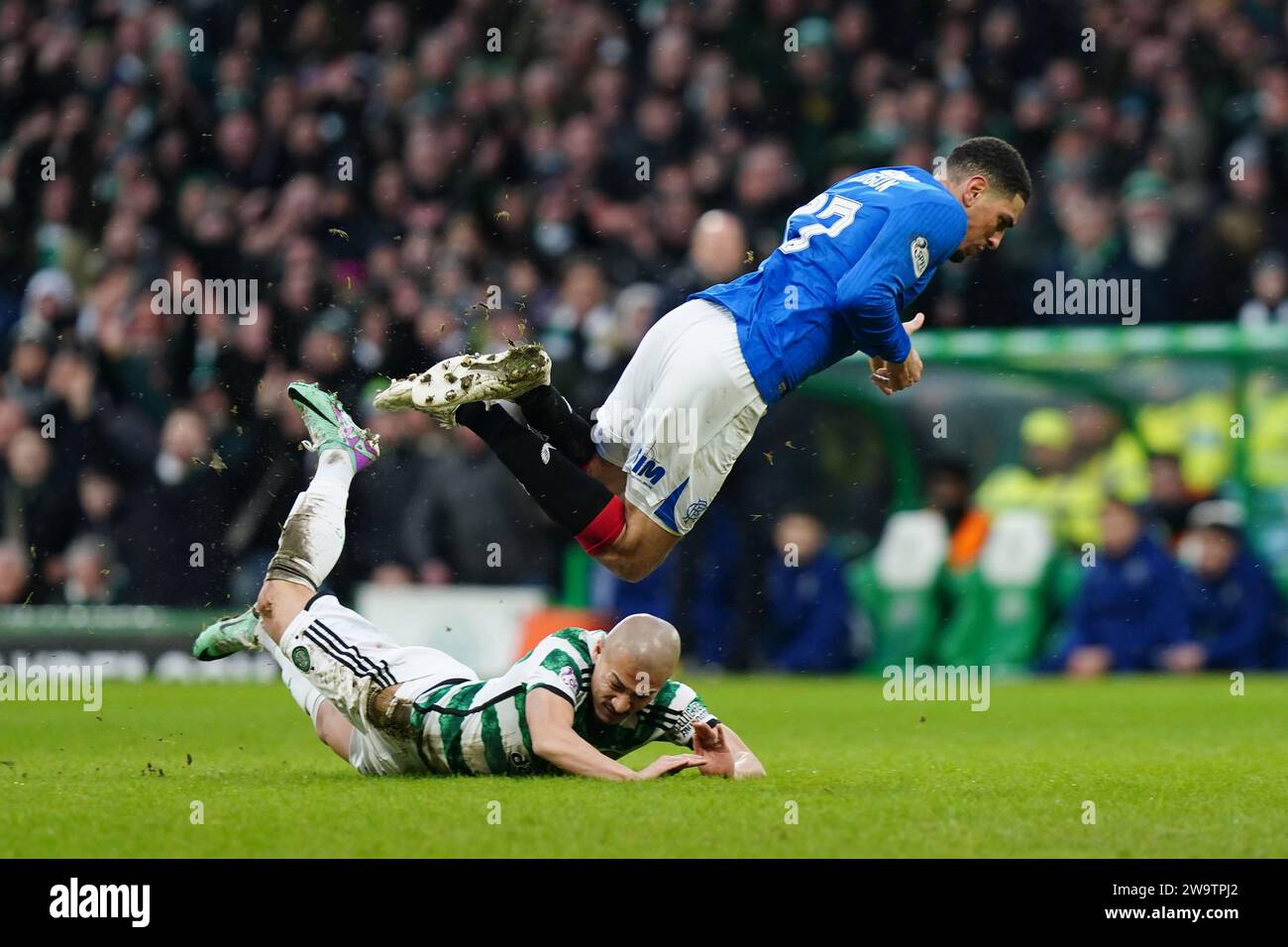 Rangers' Leon Balogun (right) fouls Celtic's Daizen Maeda and is shown ...