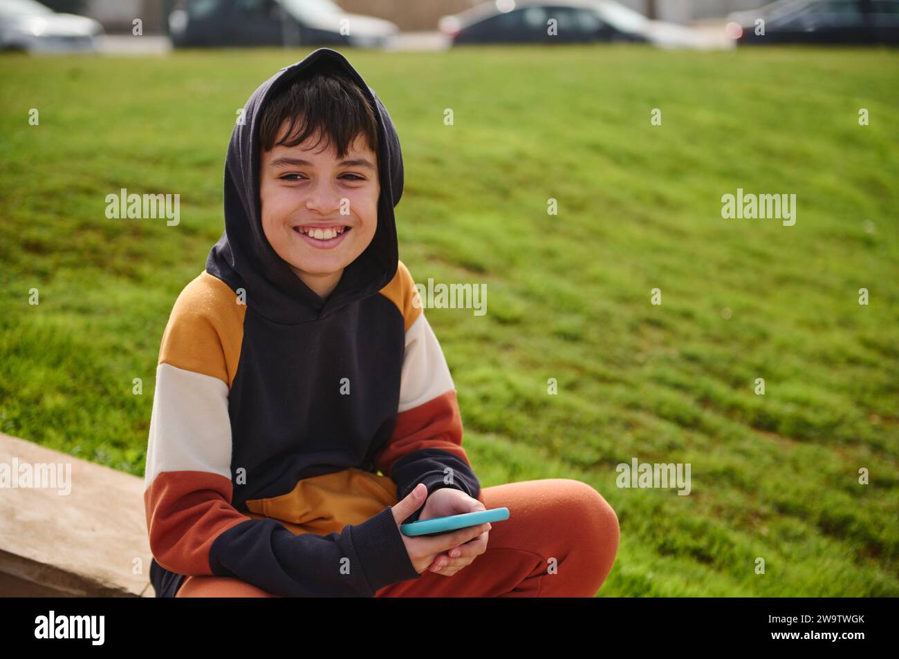 Confident portrait of multi ethnic preteen boy in stylish hoodie ...