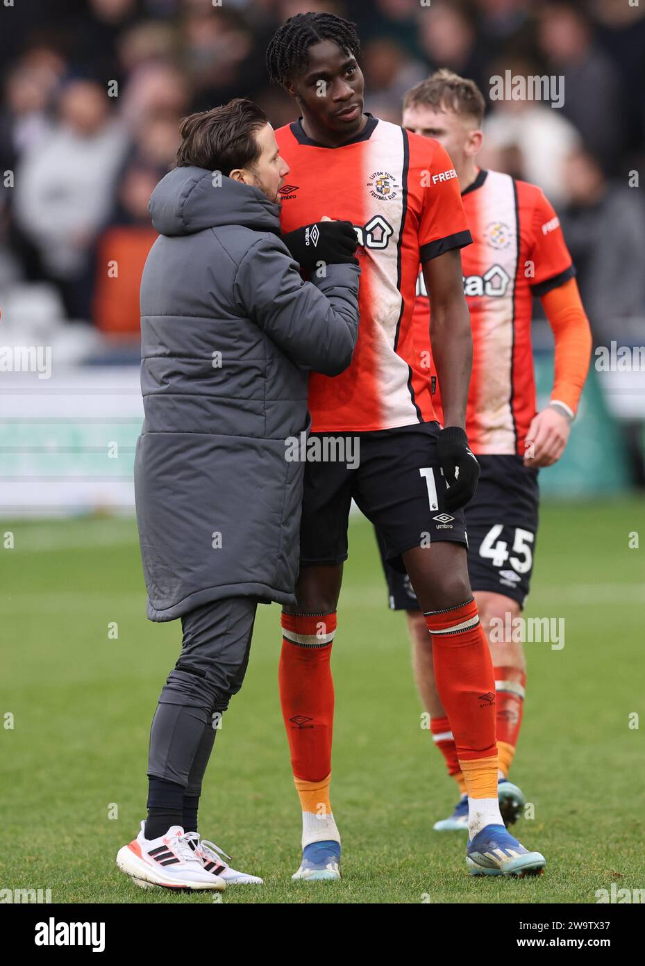 Luton, UK. 30th Dec, 2023. Elijah Adebayo of Luton Town consoled during ...
