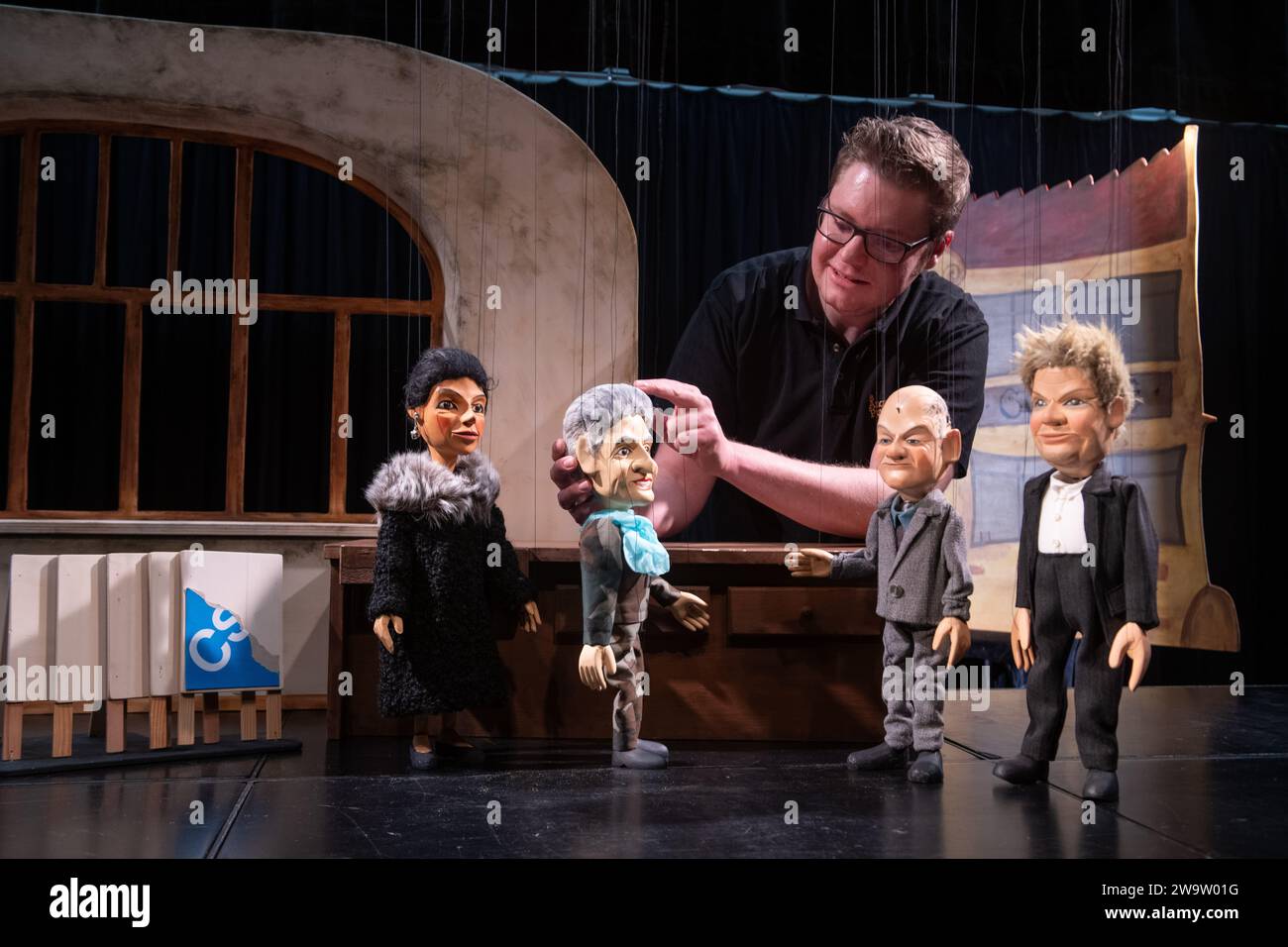 Augsburg, Germany. 30th Dec, 2023. Puppet carver Florian Moch drapes ...