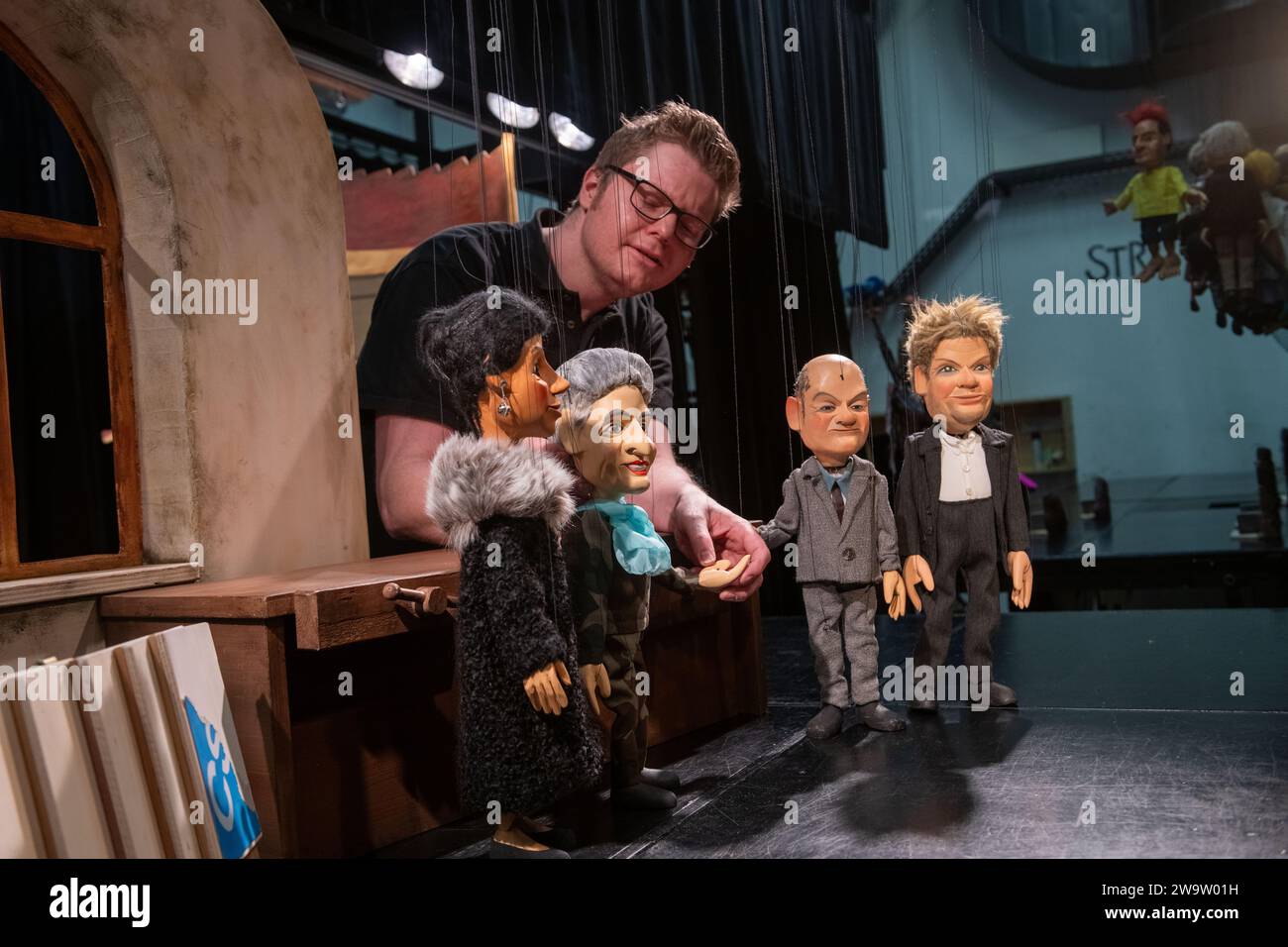 Augsburg, Germany. 30th Dec, 2023. Puppet carver Florian Moch drapes ...