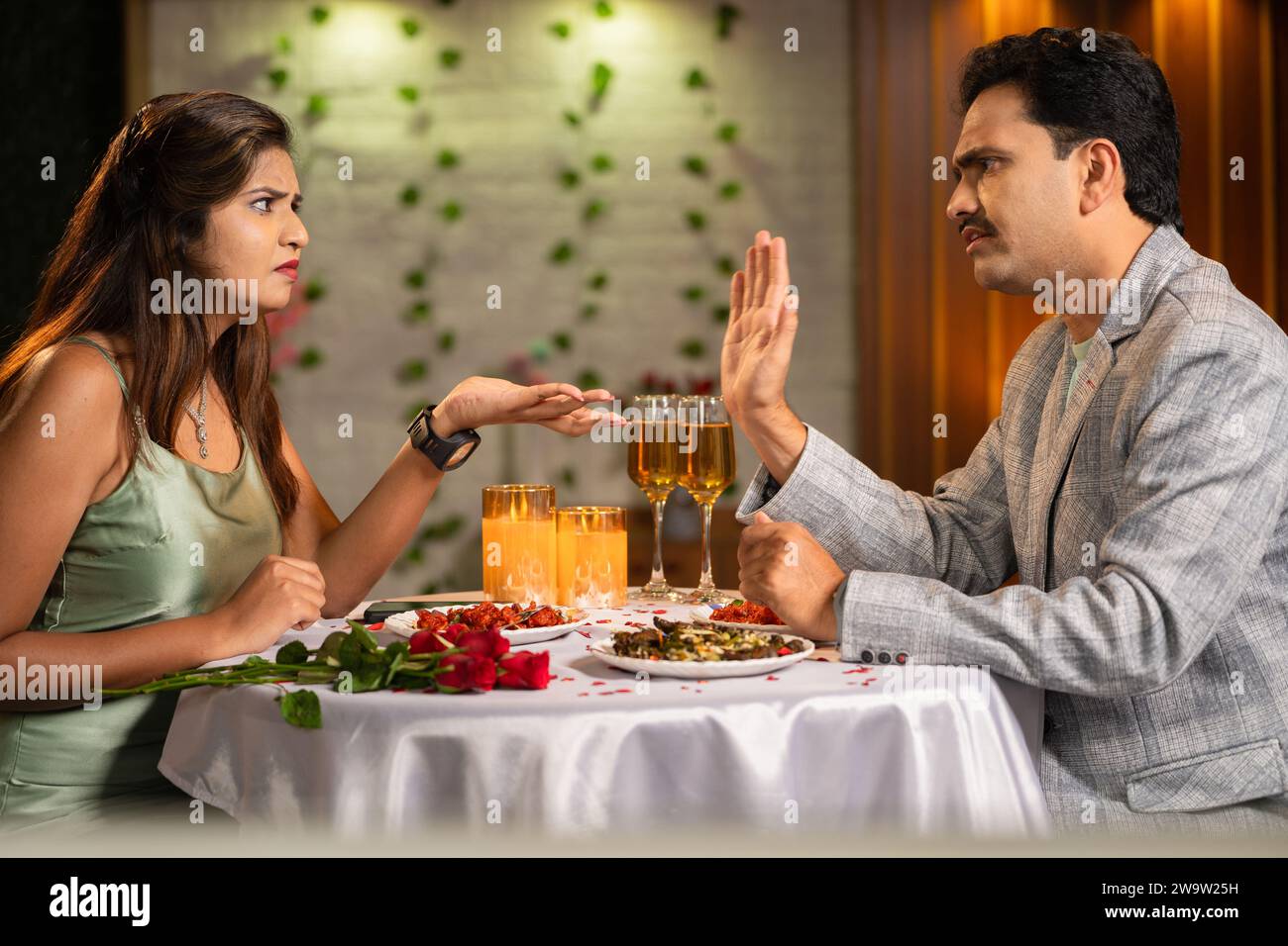 Angry Indian couples arguing each other at candlelight dinner during ...