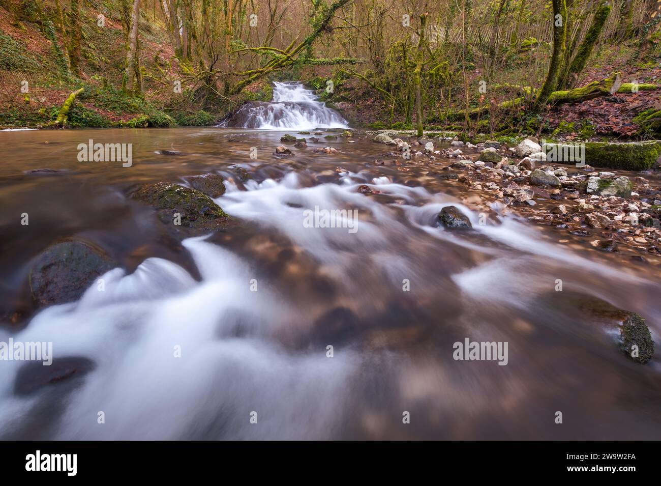 Waterfall on the Autoire river through a woodland near the village of ...