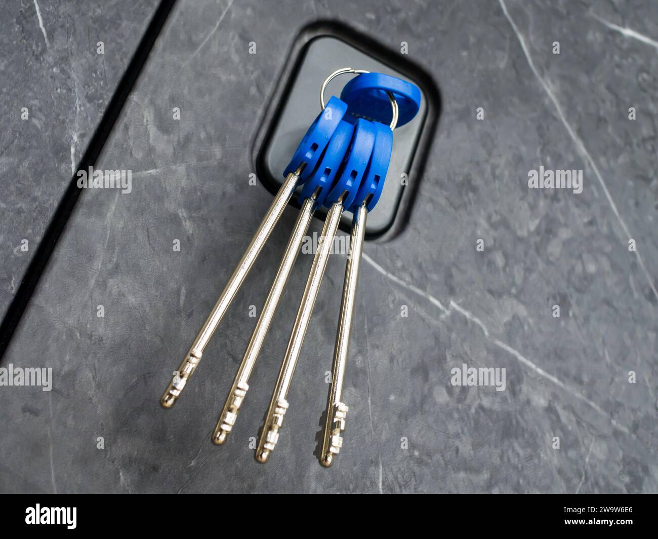 Lever key in the keyhole of the front door Stock Photo - Alamy