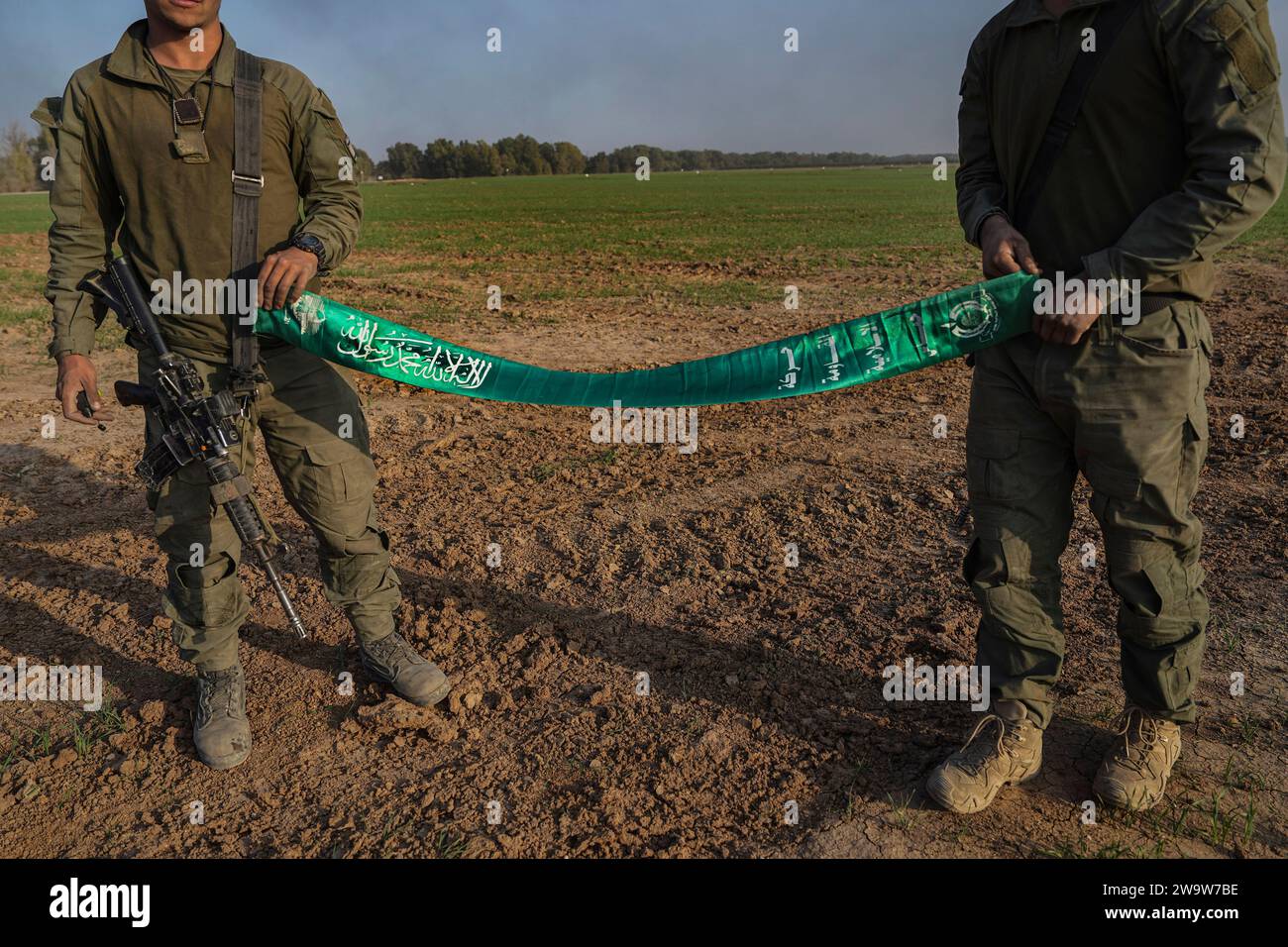 Israeli soldiers display a Hamas scarf they brought after arriving from ...