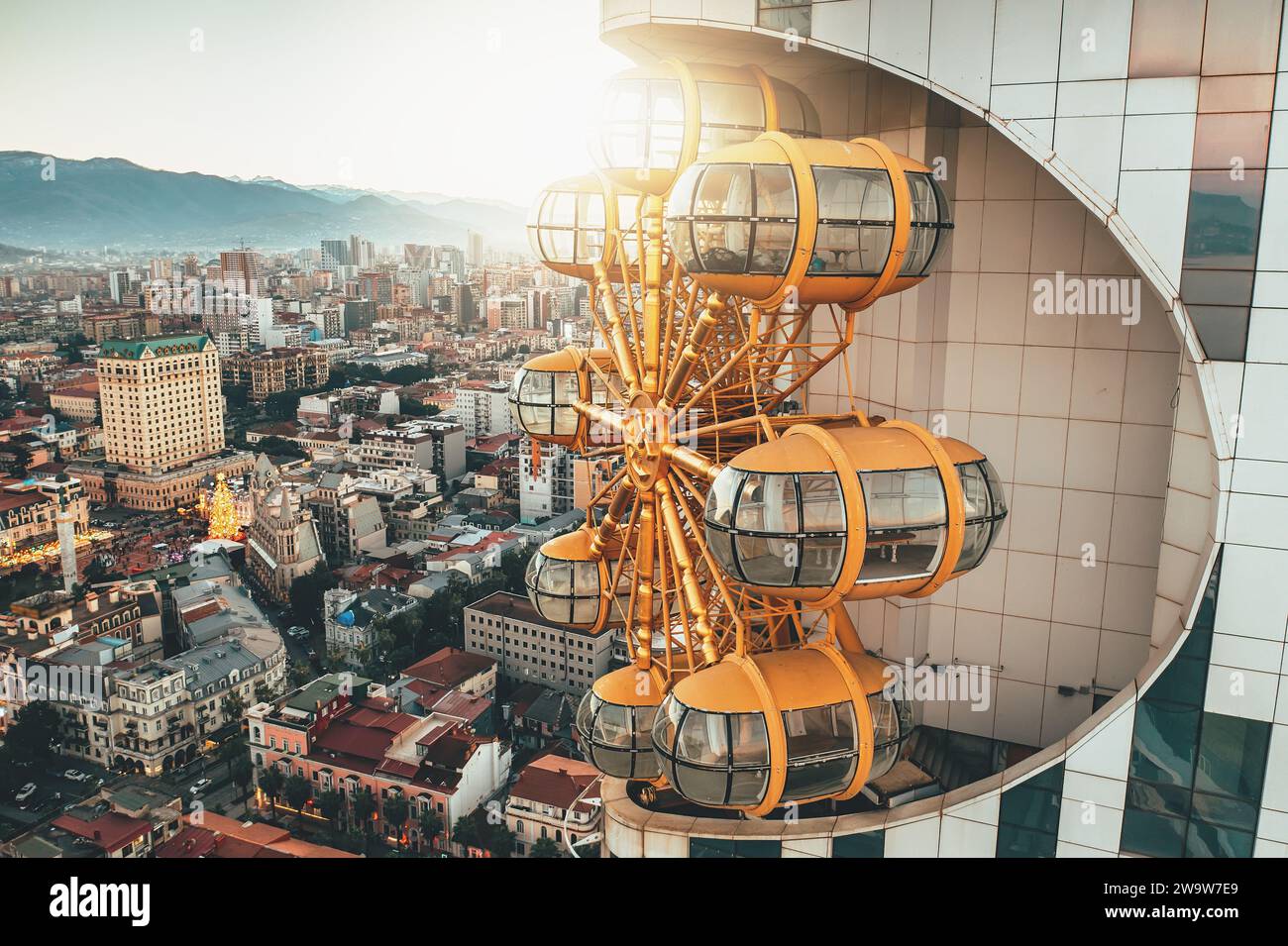 Aerial drone view of Ferris wheel built into skyscraper tower with ...