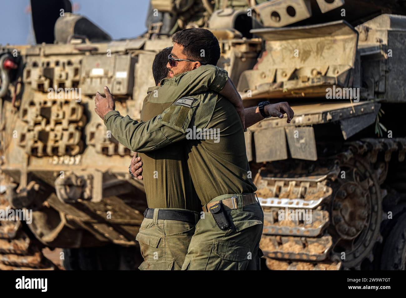 Israeli soldiers embrace after arriving from combat in the Gaza Strip ...