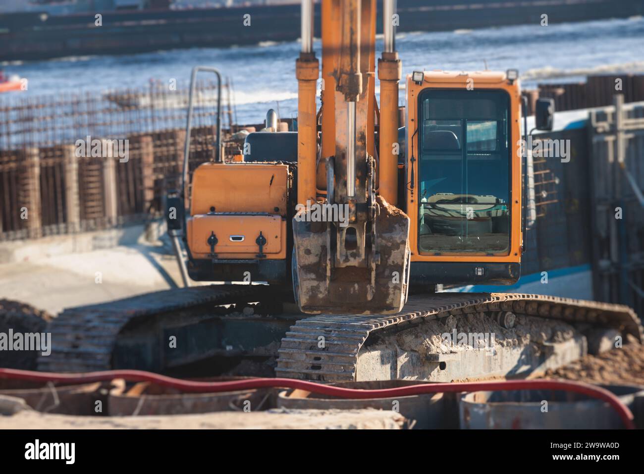Excavator unloading sand into the dump truck on the construction site ...