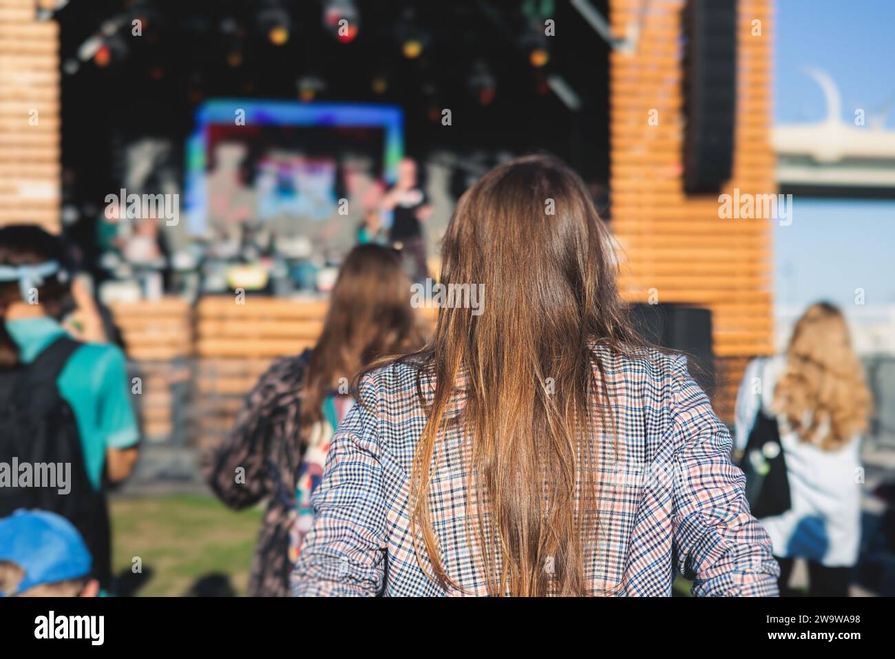 Crowded open air festival concert with scene lights with musicians band ...