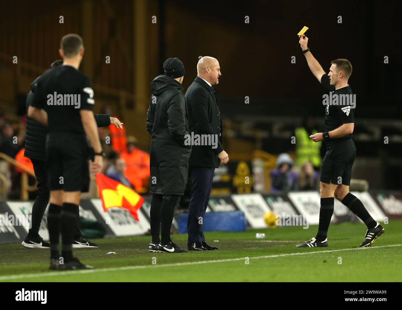 Referee Thomas Bramall (right) shows a yellow card to an Everton member ...