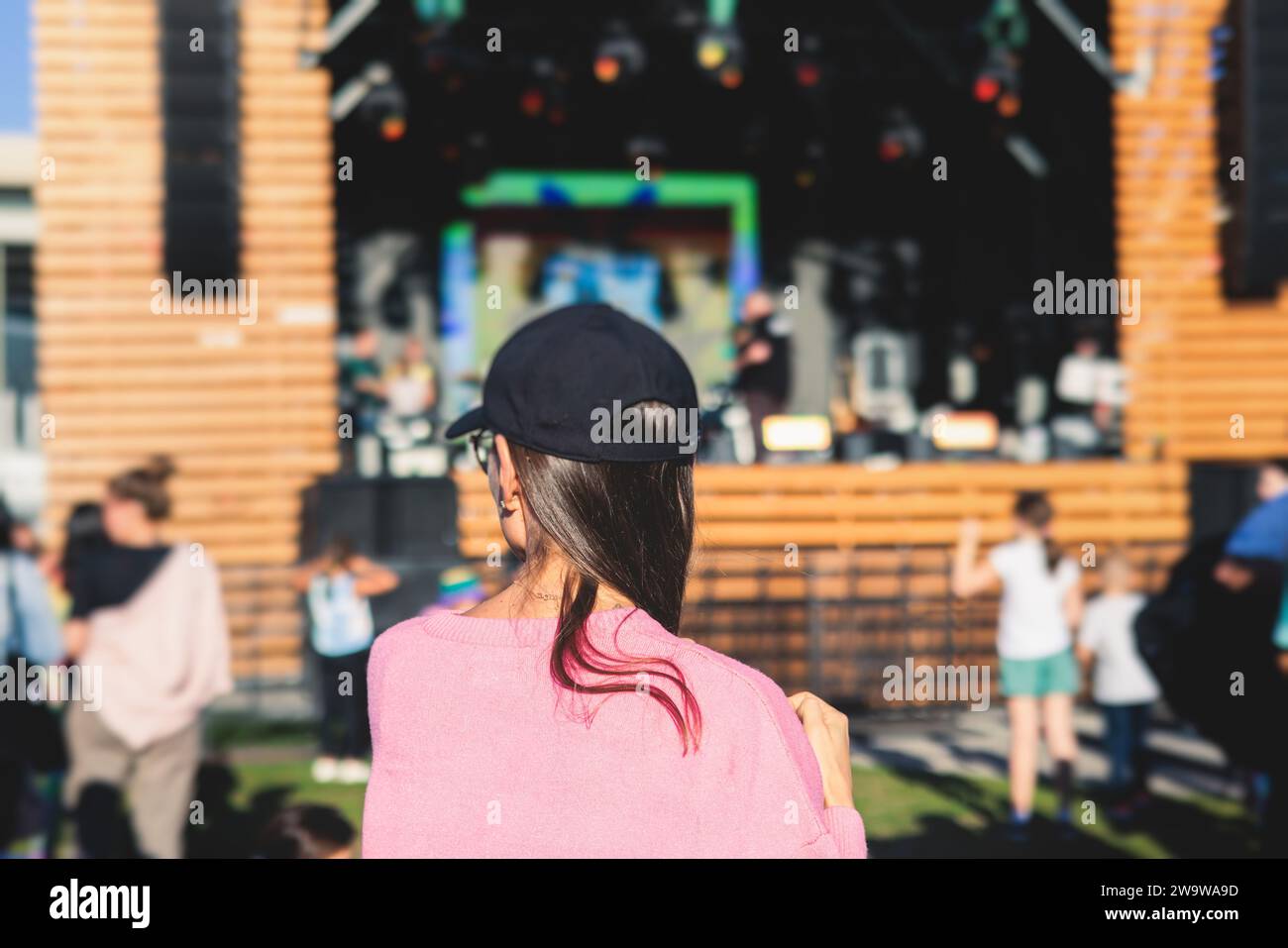 Crowded open air festival concert with scene lights with musicians band ...