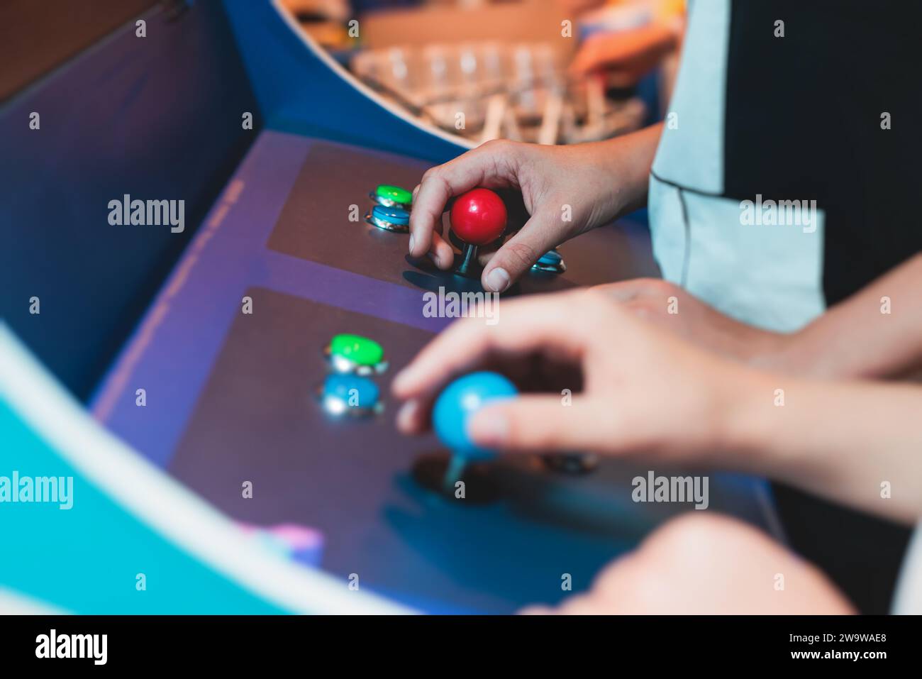 Kids play slot machine at amusement theme park, children play arcade ...