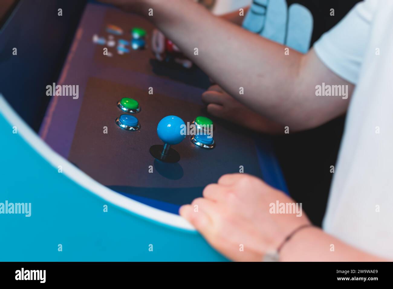 Kids play slot machine at amusement theme park, children play arcade ...