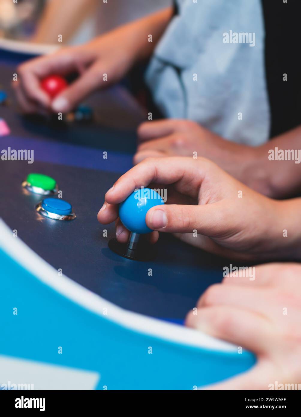 Kids play slot machine at amusement theme park, children play arcade ...