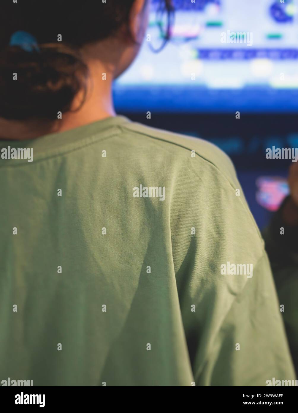 Kids play slot machine at amusement theme park, children play arcade ...