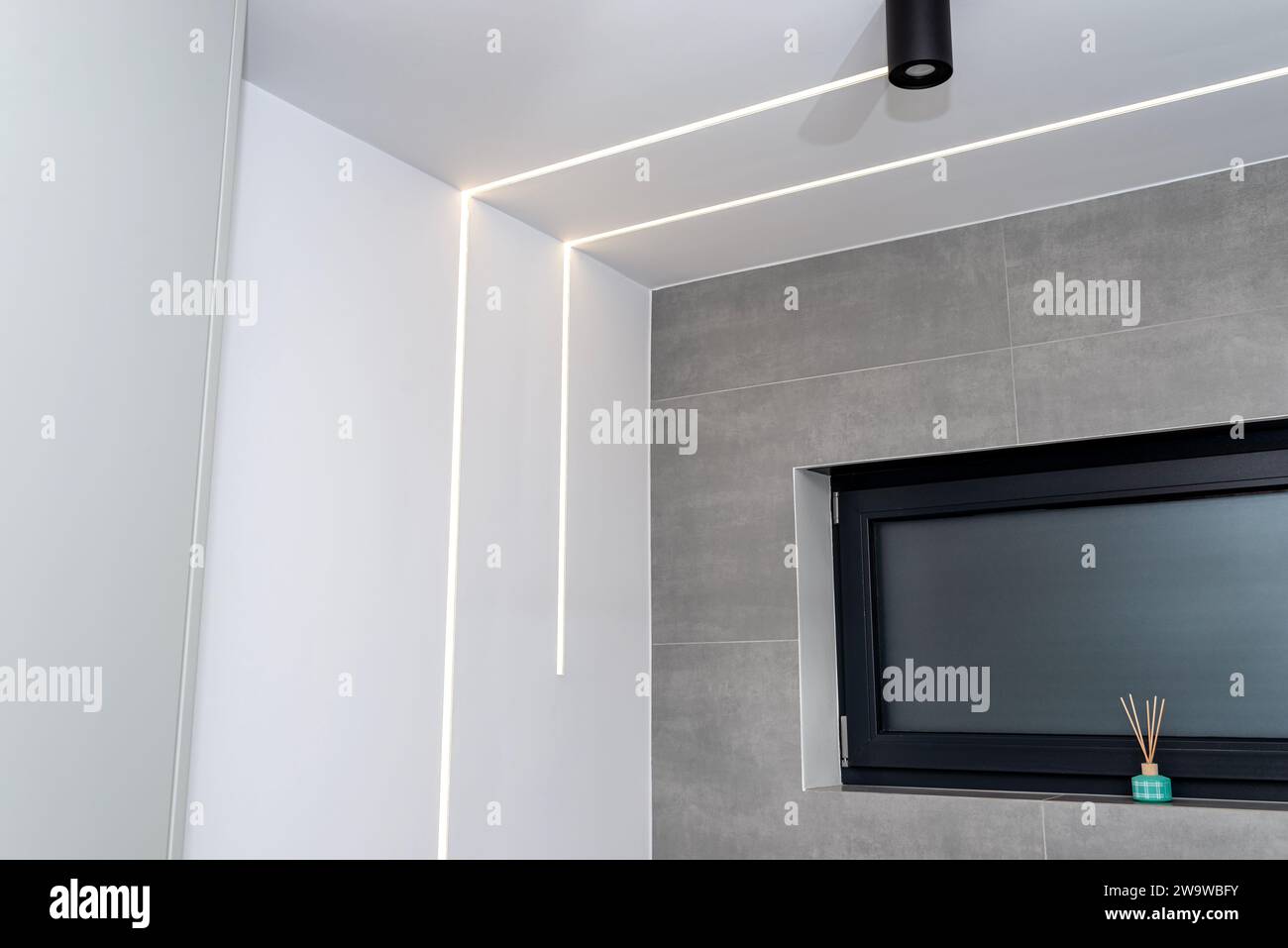 LED light strips mounted in the wall and ceiling in a modern bathroom ...