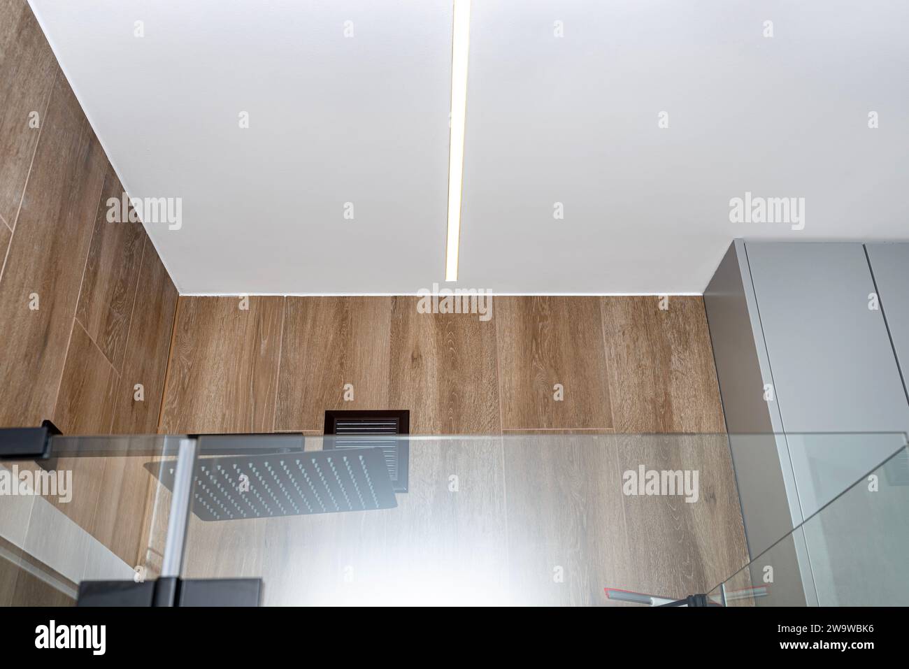 LED light strips mounted in the wall in a modern bathroom, visible ...