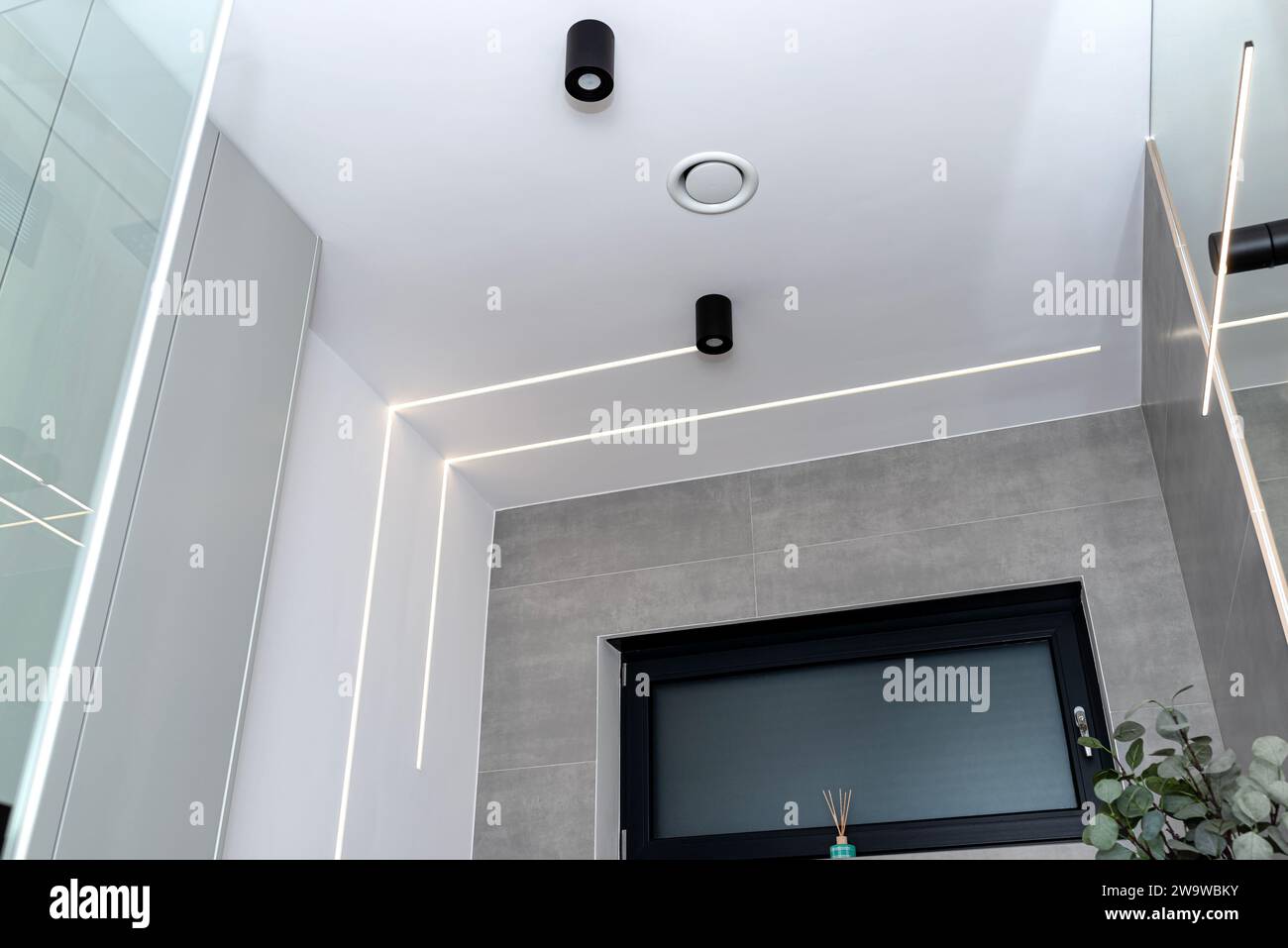 LED light strips mounted in the wall and ceiling in a modern bathroom ...