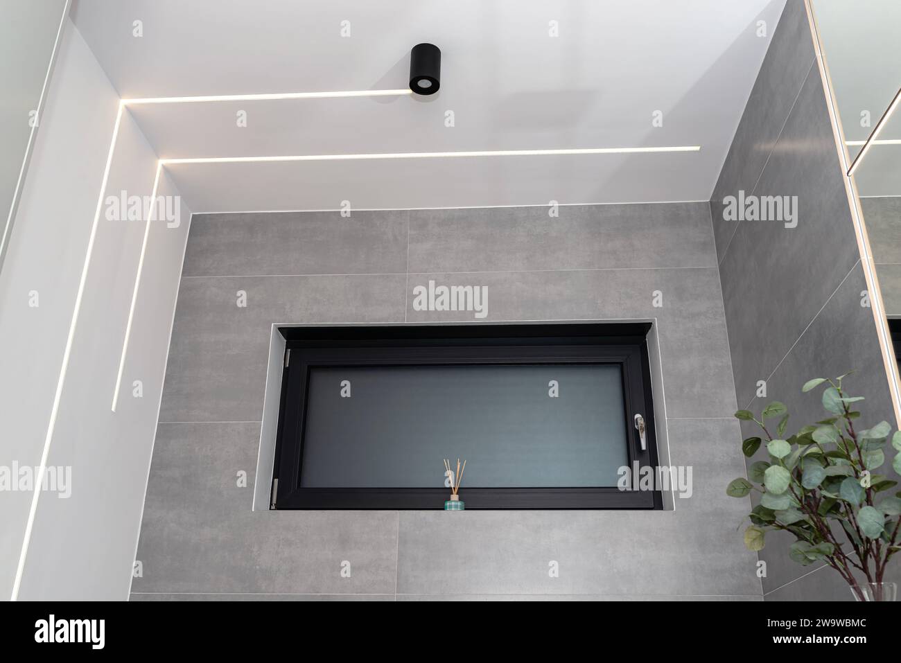 LED light strips mounted in the wall and ceiling in a modern bathroom ...