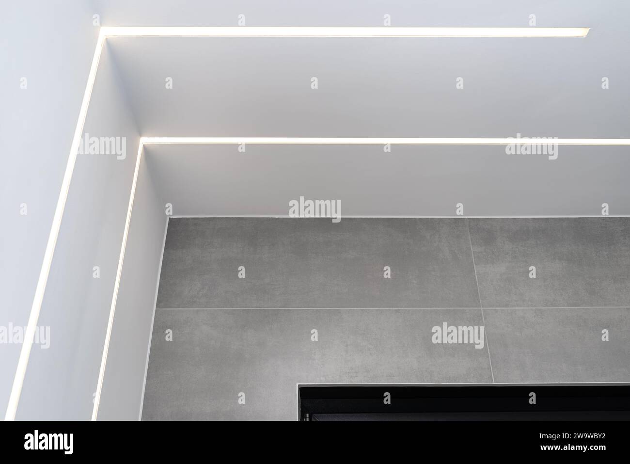 LED light strips mounted in the wall and ceiling in a modern bathroom ...