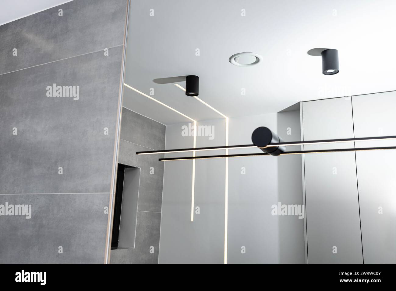 LED light strips mounted in the wall and ceiling in a modern bathroom ...
