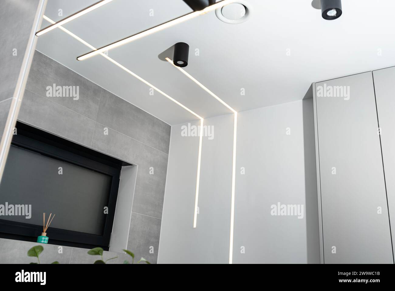 LED light strips mounted in the wall and ceiling in a modern bathroom ...