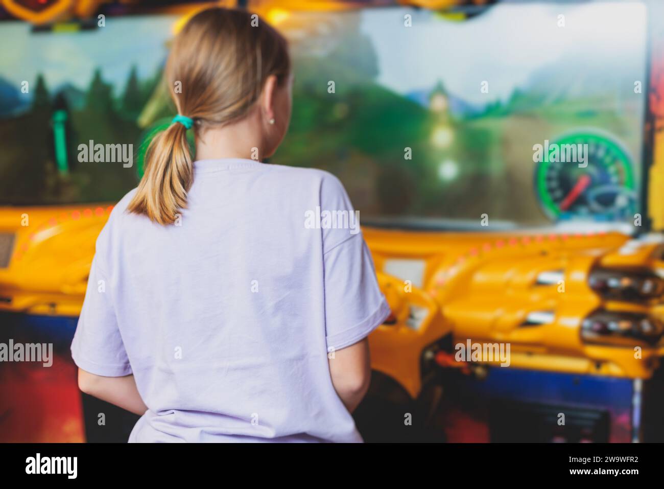 Kids play slot machine at amusement theme park, children play arcade ...