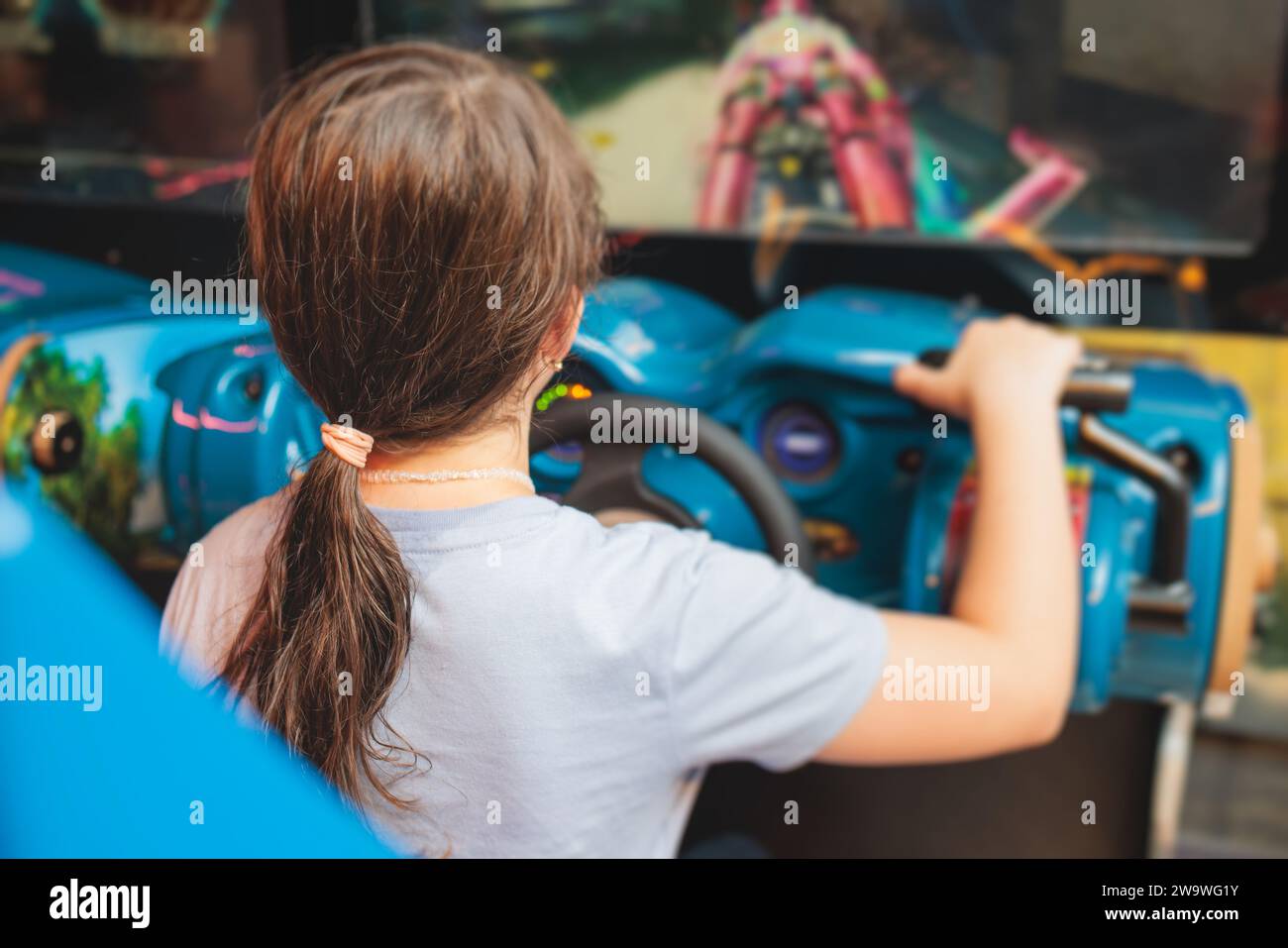 Kids play slot machine at amusement theme park, children play arcade ...