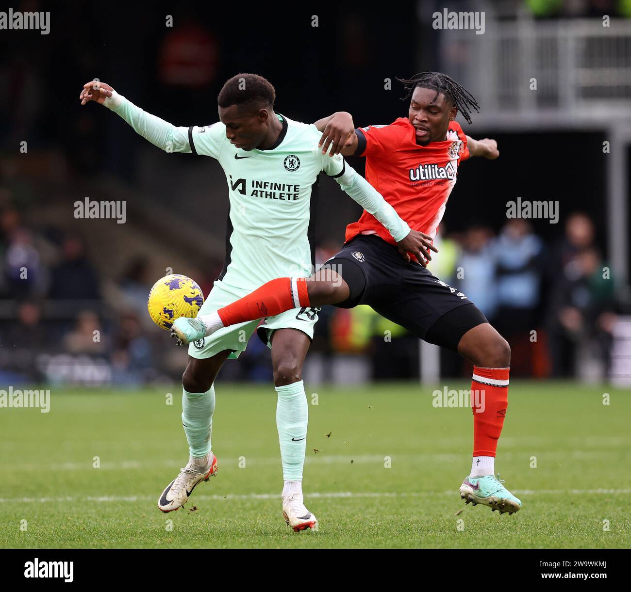London, UK. 28th Dec, 2023. Teden Mengi of Luton Town with Nicolas ...