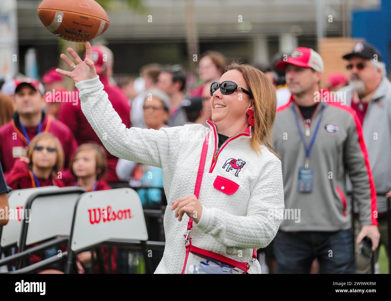 December 30, 2023:.A Georgia Fan throws a football at the Capital One ...