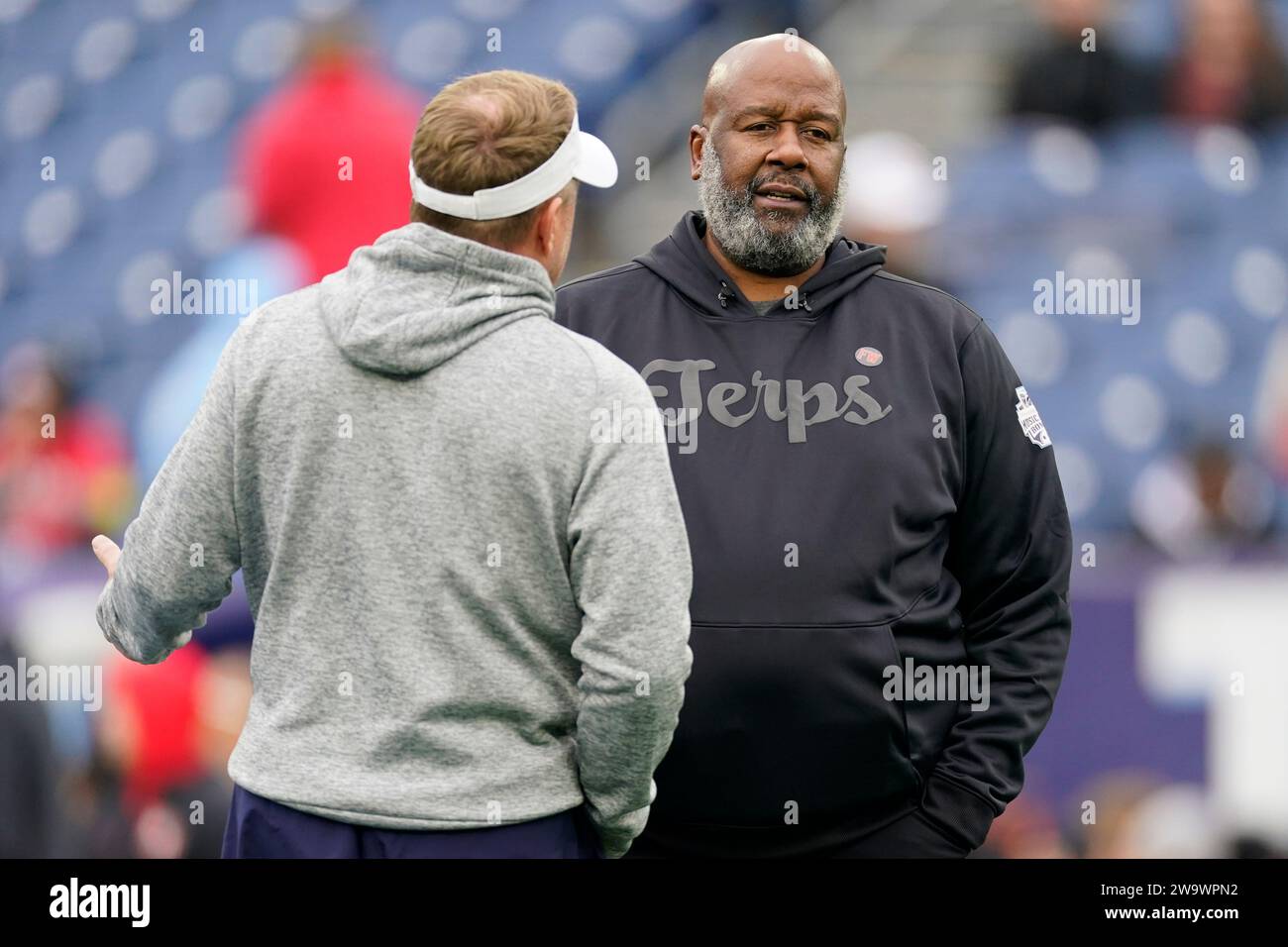 Maryland head coach Mike Locksley, right, talk to Auburn head coach ...
