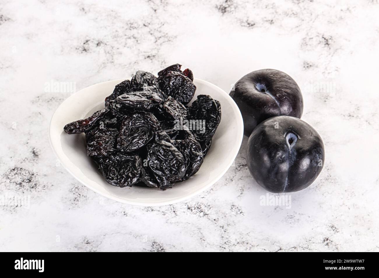 Dry sweet prunes in thw bowl Stock Photo - Alamy
