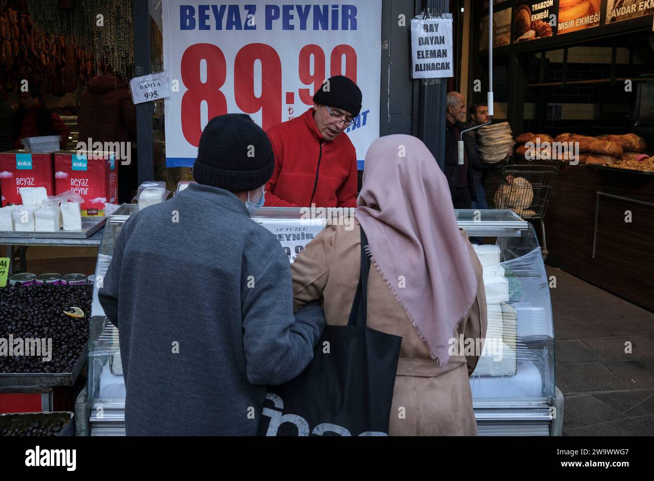 Ankara, Turkey. 30th Dec, 2023. A couple looks at cheese prices. The ...