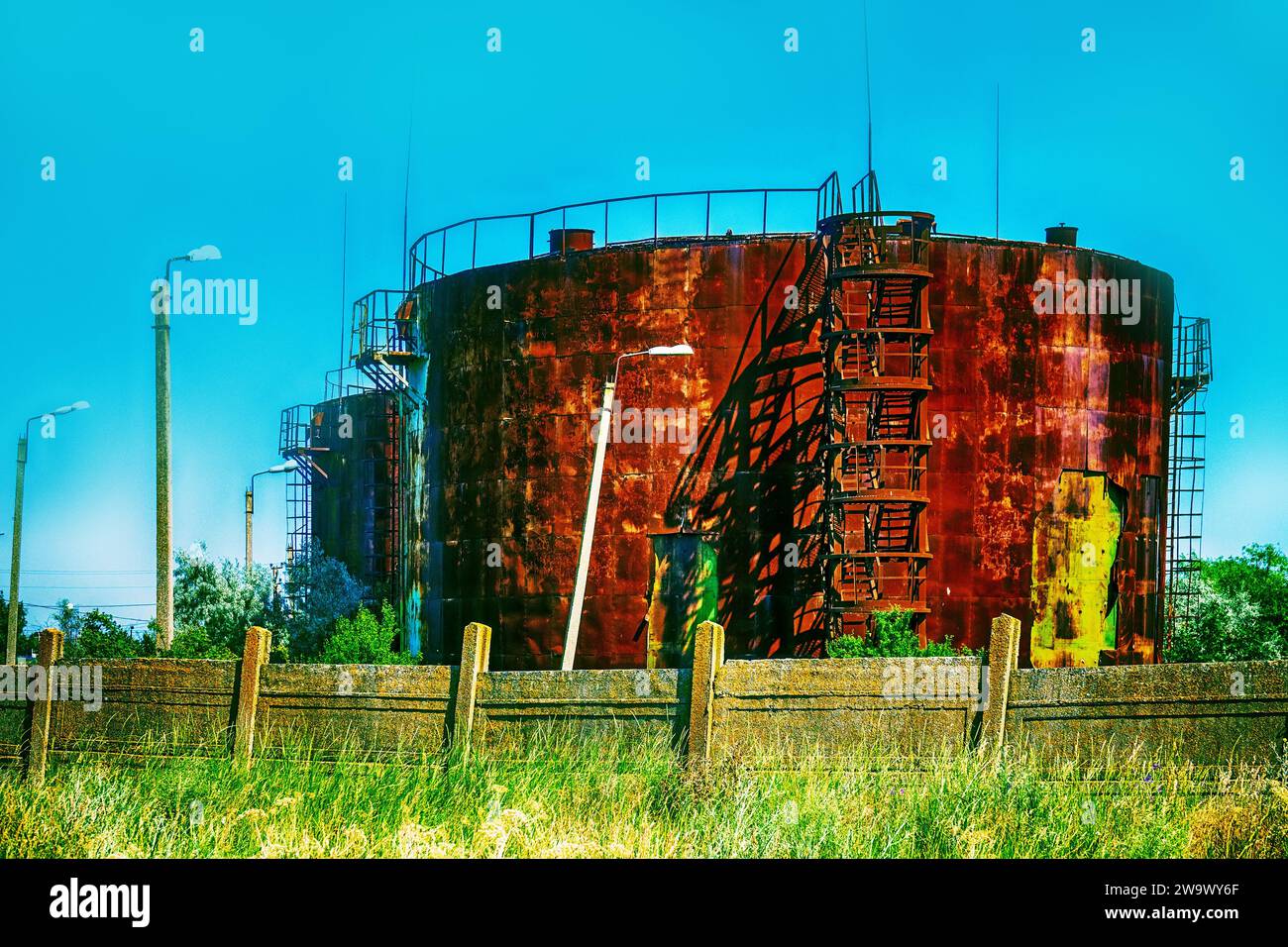 Old rusty oil tanks (fuel reservoir, oil barrel). Evidence of economic ...