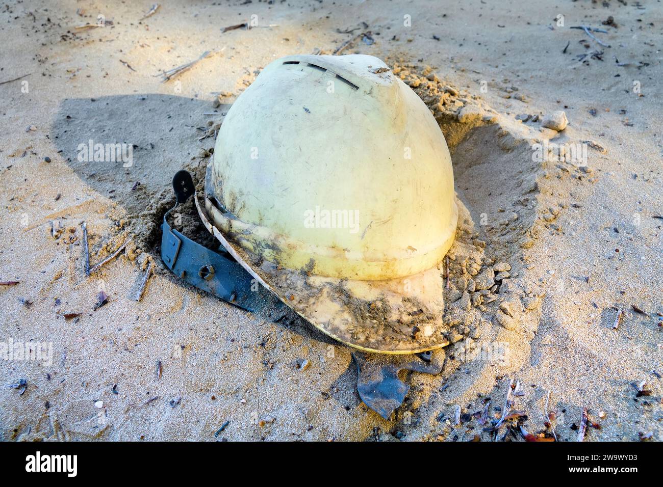 Hastily abandoned construction helmet in the sand Stock Photo - Alamy