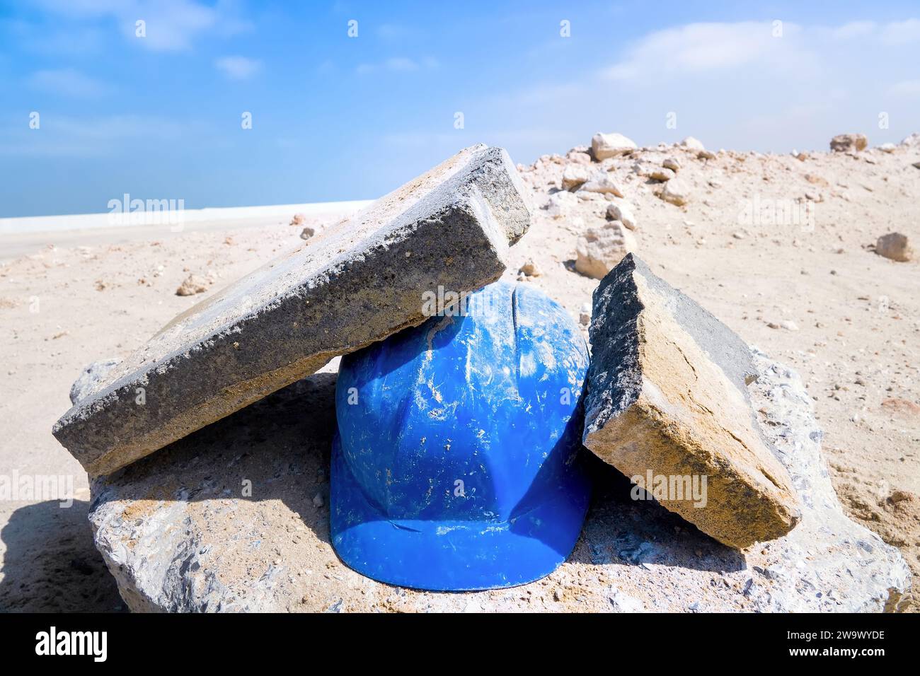 Hastily abandoned construction helmet in sand. Helmet is able to ...