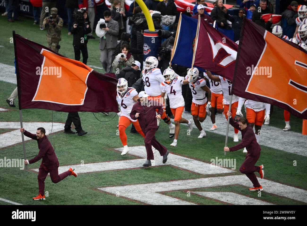 Virginia Tech takes to the field before the Military Bowl NCAA college ...
