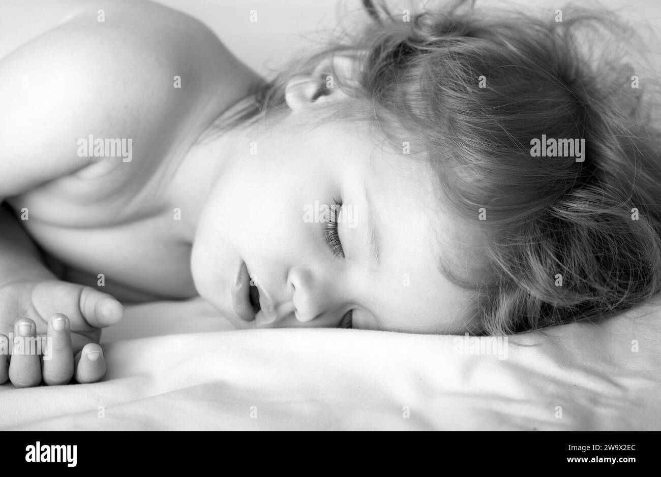 Funny baby child sleeping in the bed. Closeup sleepy kids face Stock Photo - Alamy