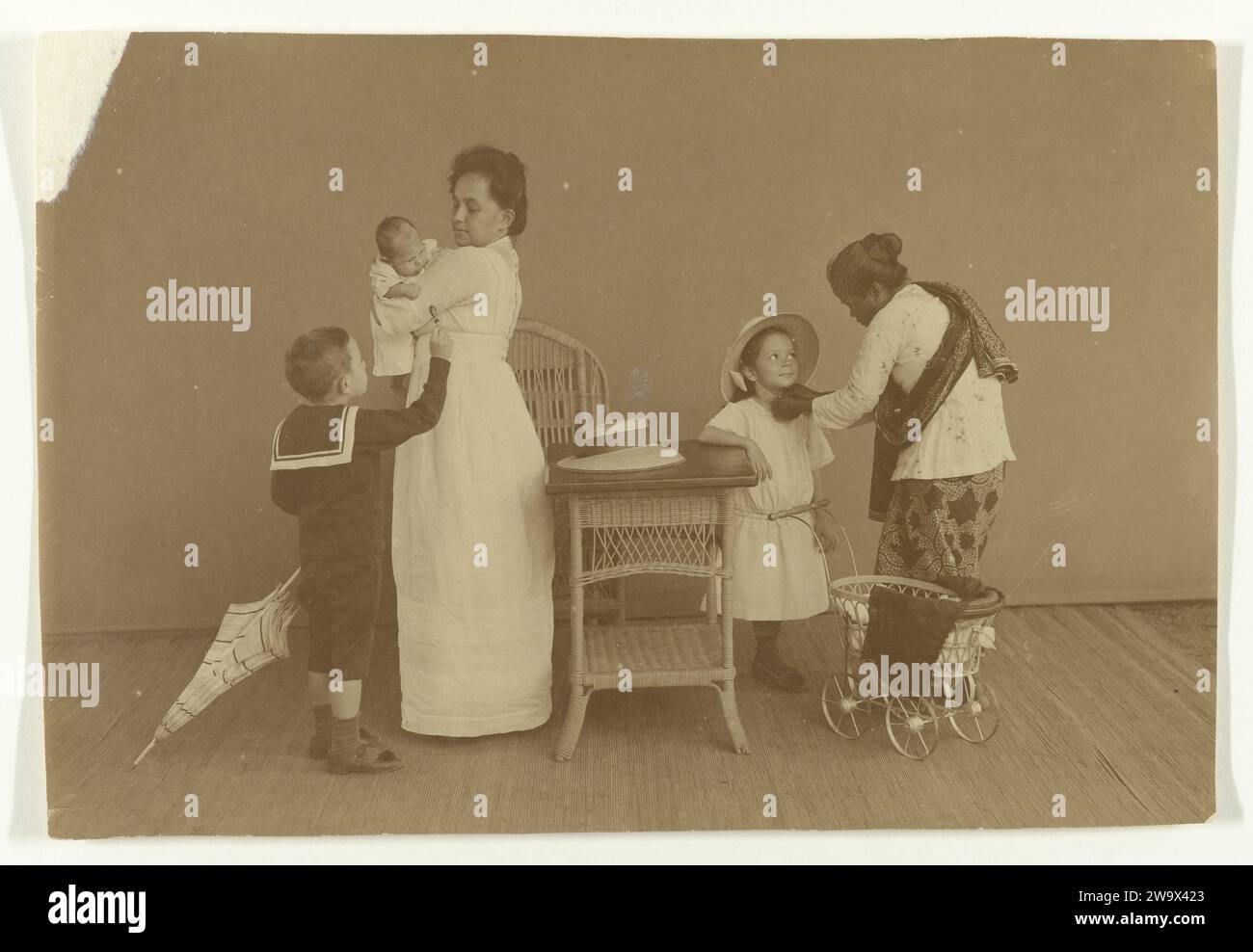 Three unknown children with their mother and their Indonesian childcare ...