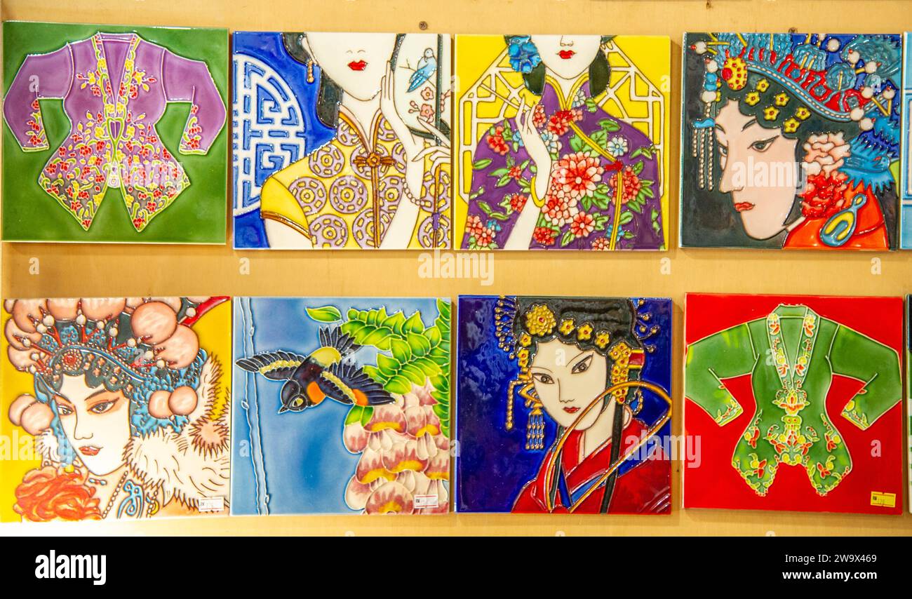Square porcelain tiles painted with brightly coloured faces of Asian ...