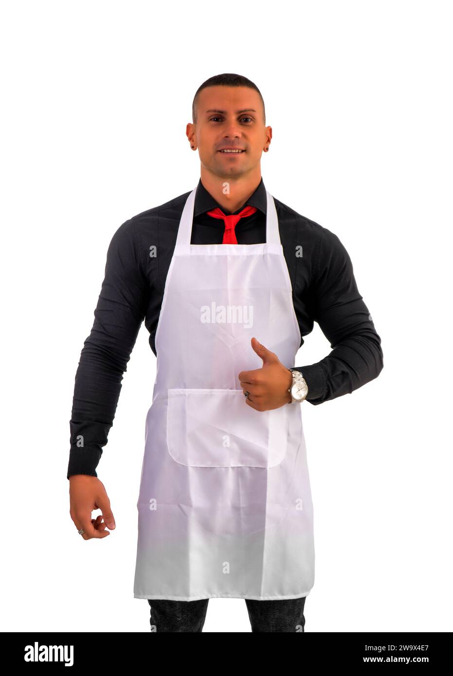 Attractive chef or waiter posing, wearing white apron and black shirt ...