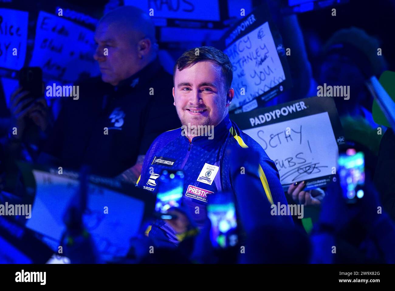 Luke Littler walks out to play Raymond van Barneveld (not pictured) on ...